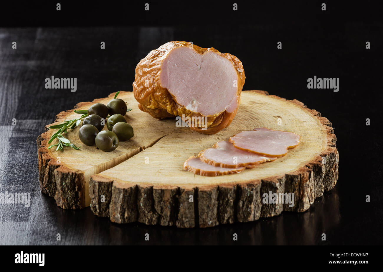 Smoked meat and olives over black background Stock Photo - Alamy