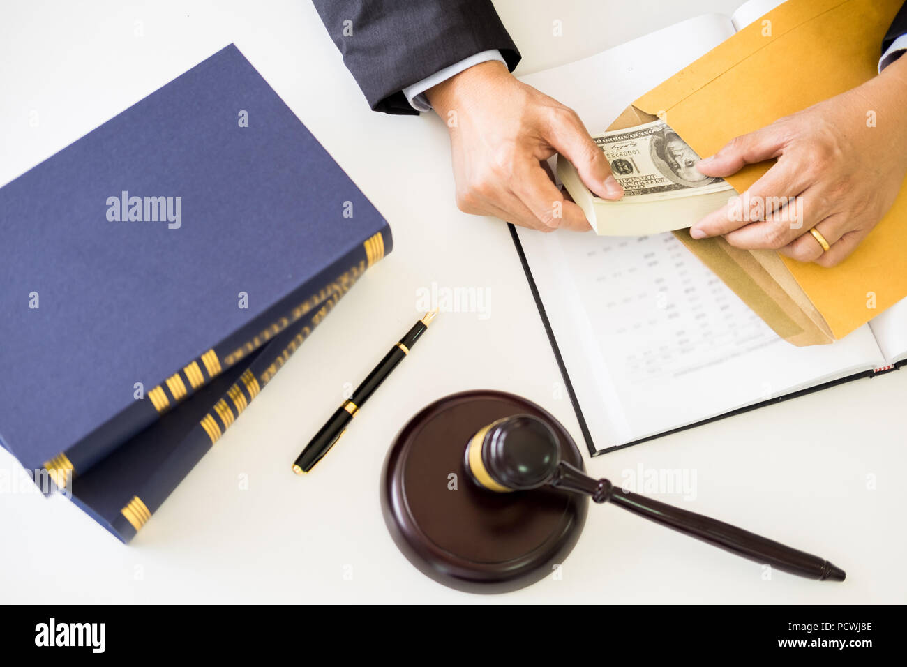 Lawyer being offered receiving money as bribe from client at desk in ...