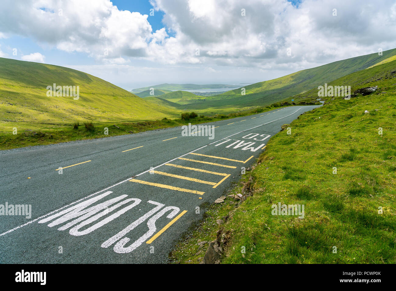 Slow down road marking Stock Photo - Alamy