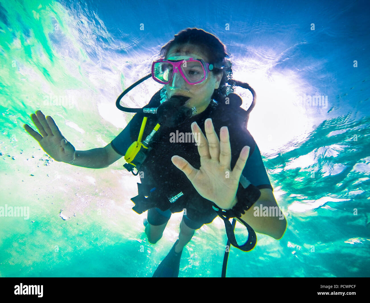 Female scuba diver equalizing the pressure on Oliveli island , Maldives ...