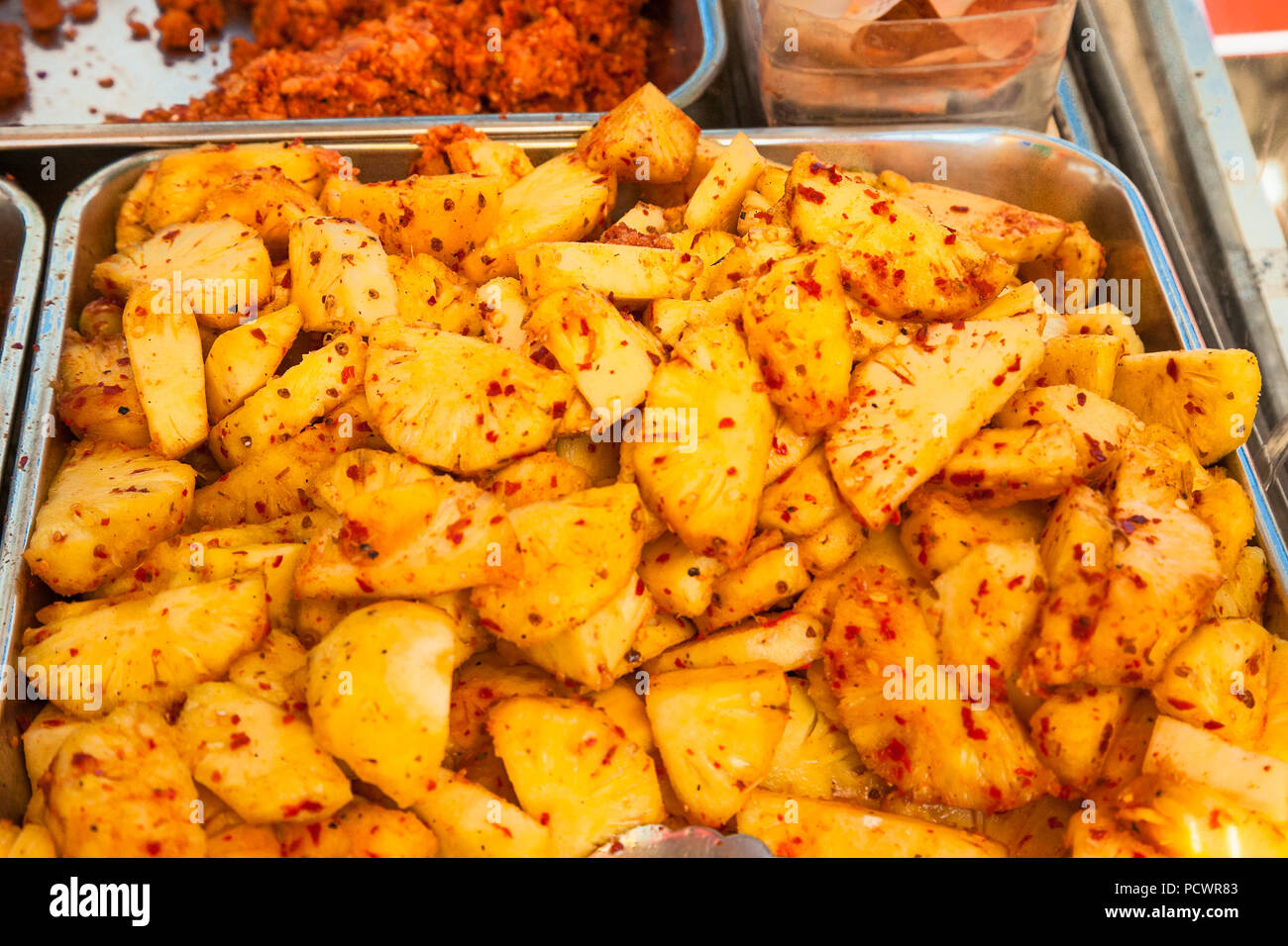 Pineapple with hot chilli peppers on a street market in Colombo. Sri ...