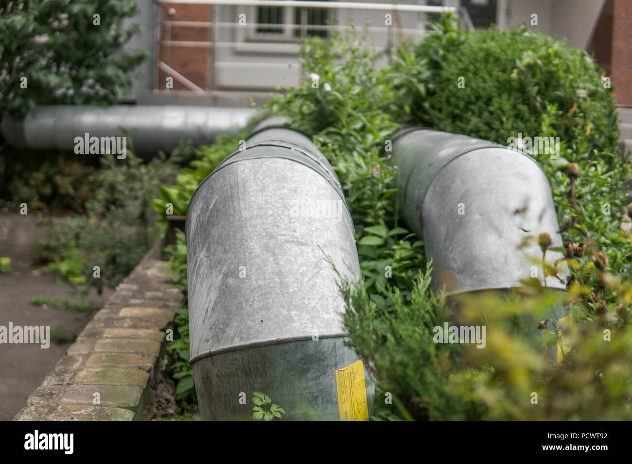 Industrial metal gas pipe in a green grass Stock Photo - Alamy