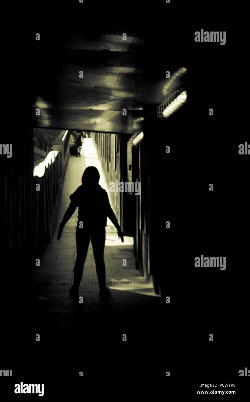 Woman alone and sad in a tunnel. Scene of mystery and desolation Stock ...
