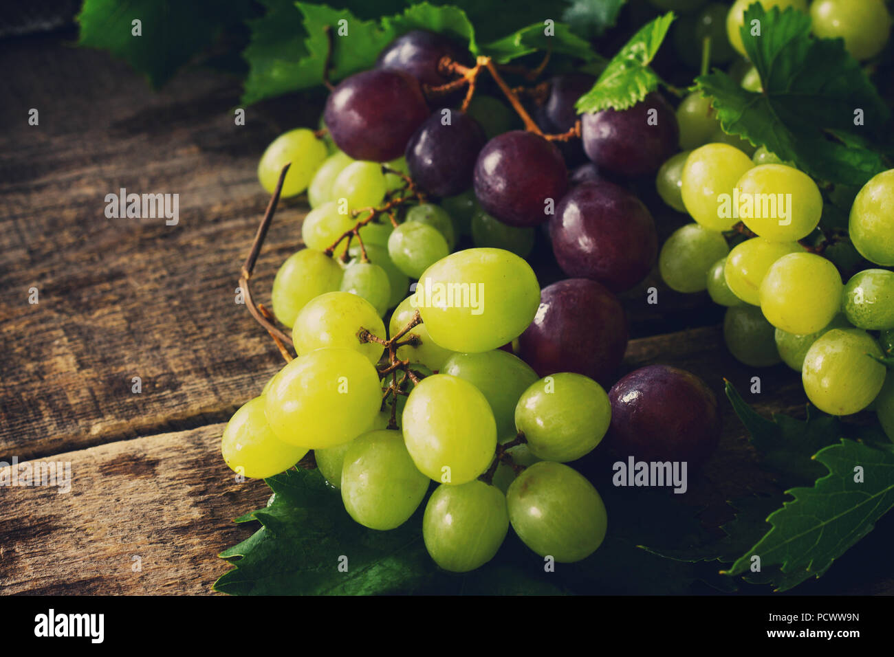 Mix grapes on vintage background. The concept of nutrition health, wine ...