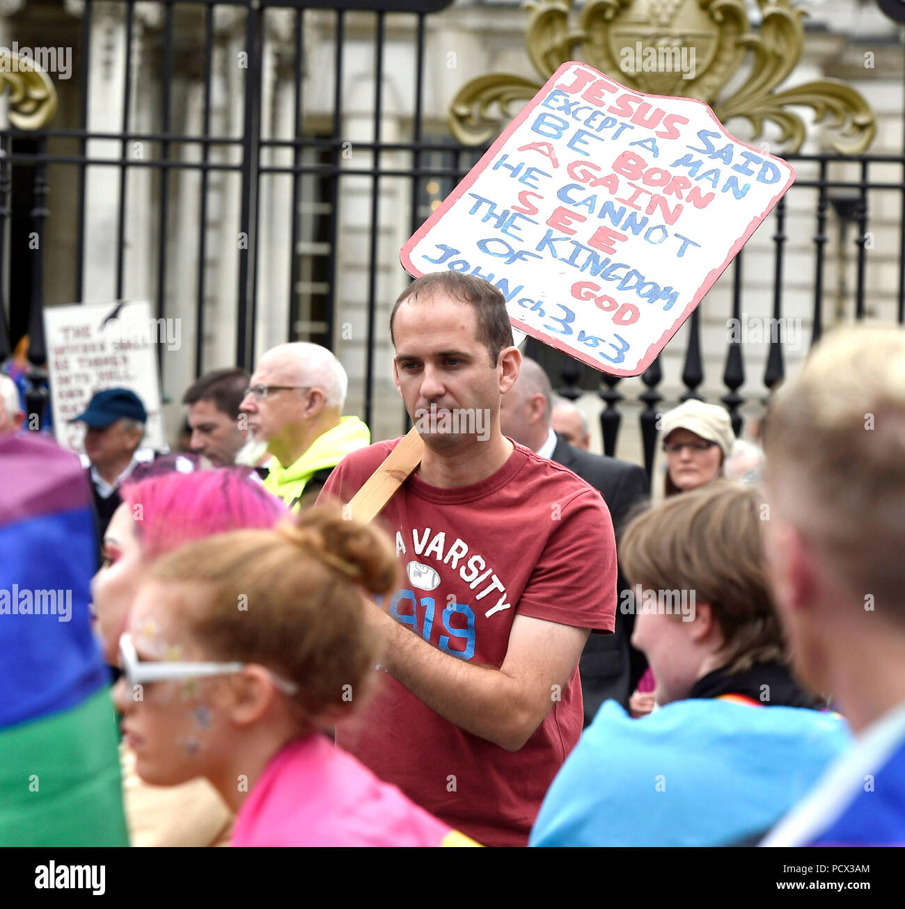 A Christian protestor talks to people taking part in the Belfast Pride ...