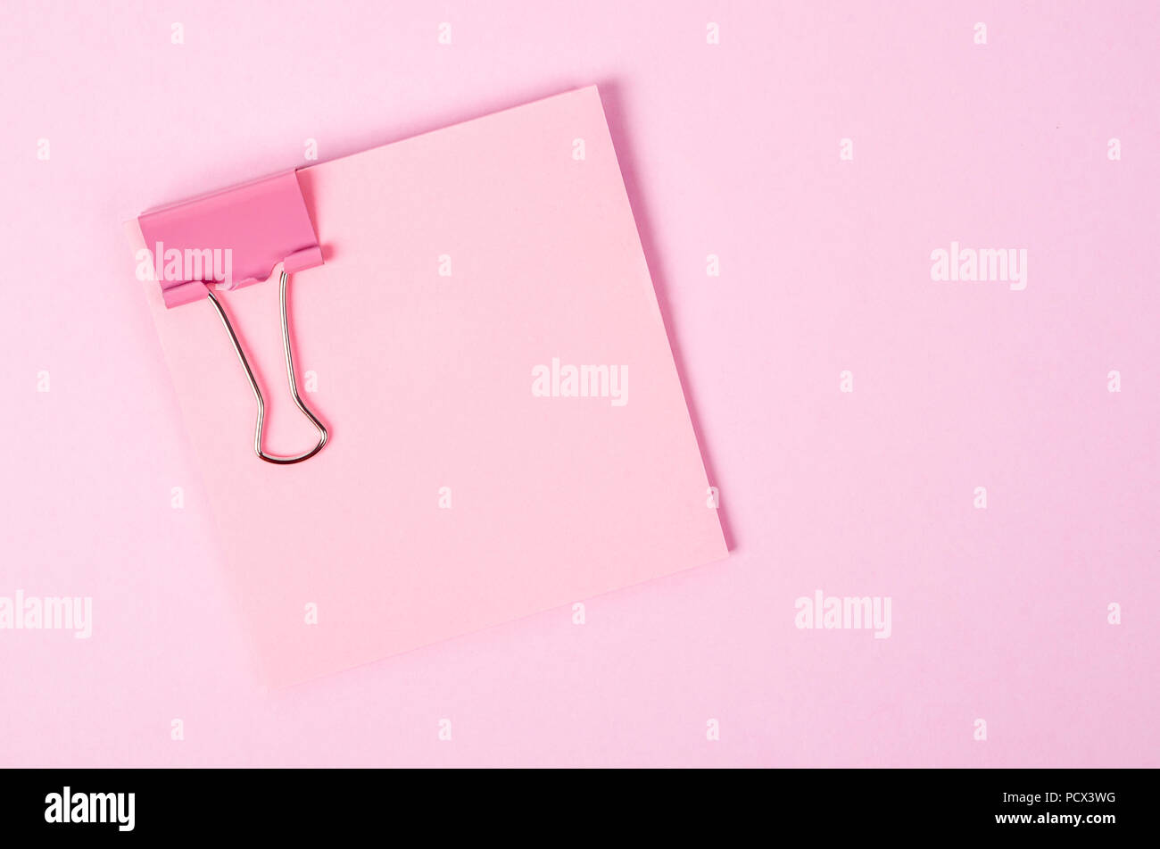 Pink binder clips and pink sticky notes on pink background Stock Photo ...