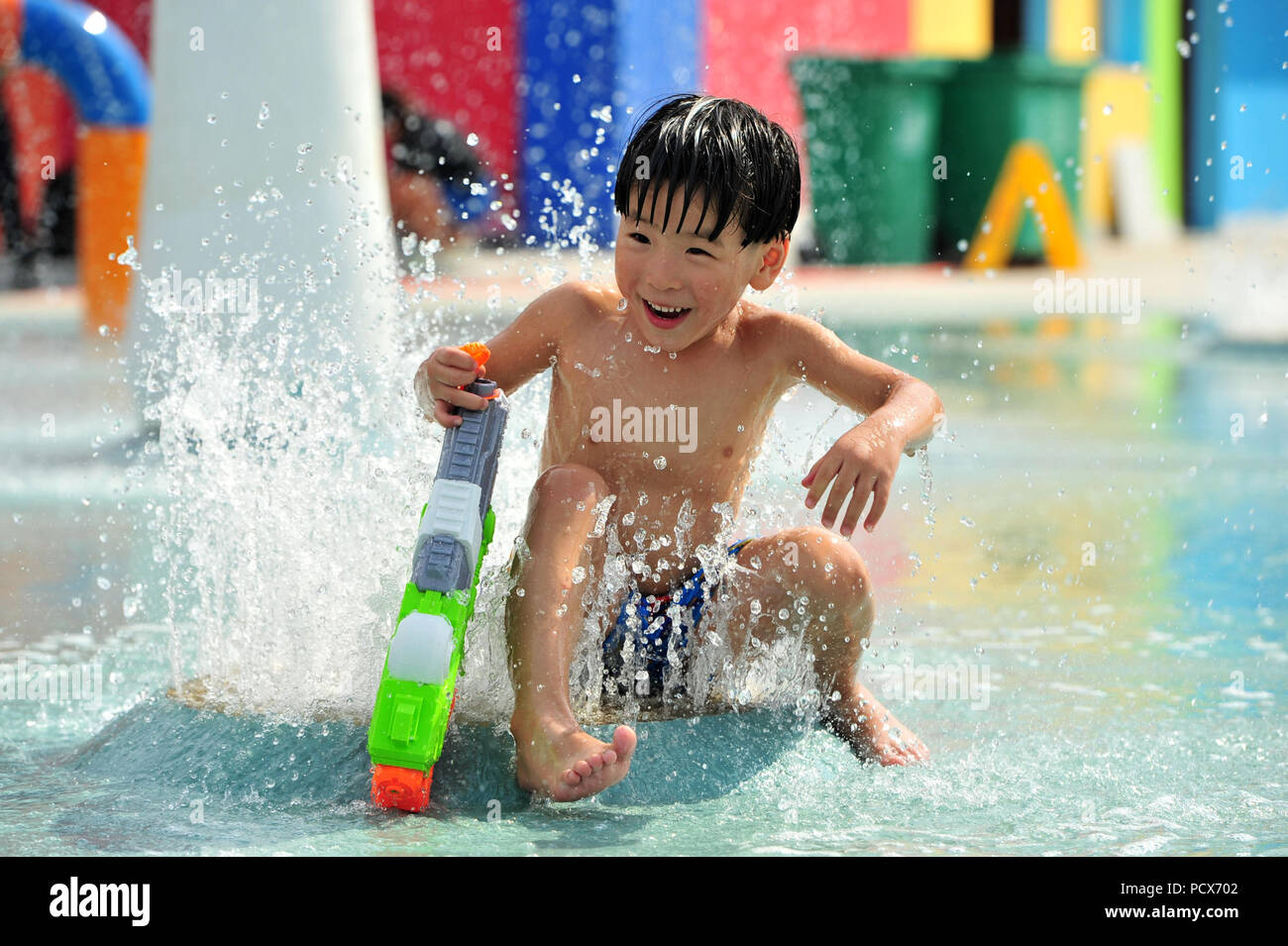 Zigui, China's Hubei Province. 4th Aug, 2018. A child enjoys coolness ...