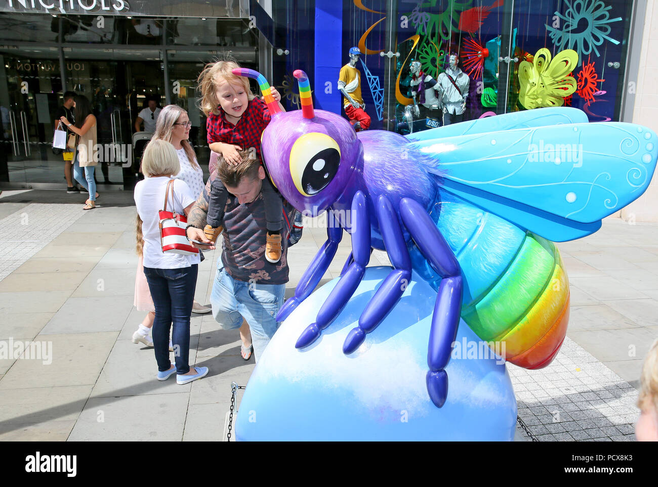 Manchester, UK, 3 Aug 2018. A youngster exploring a giant Bee ...