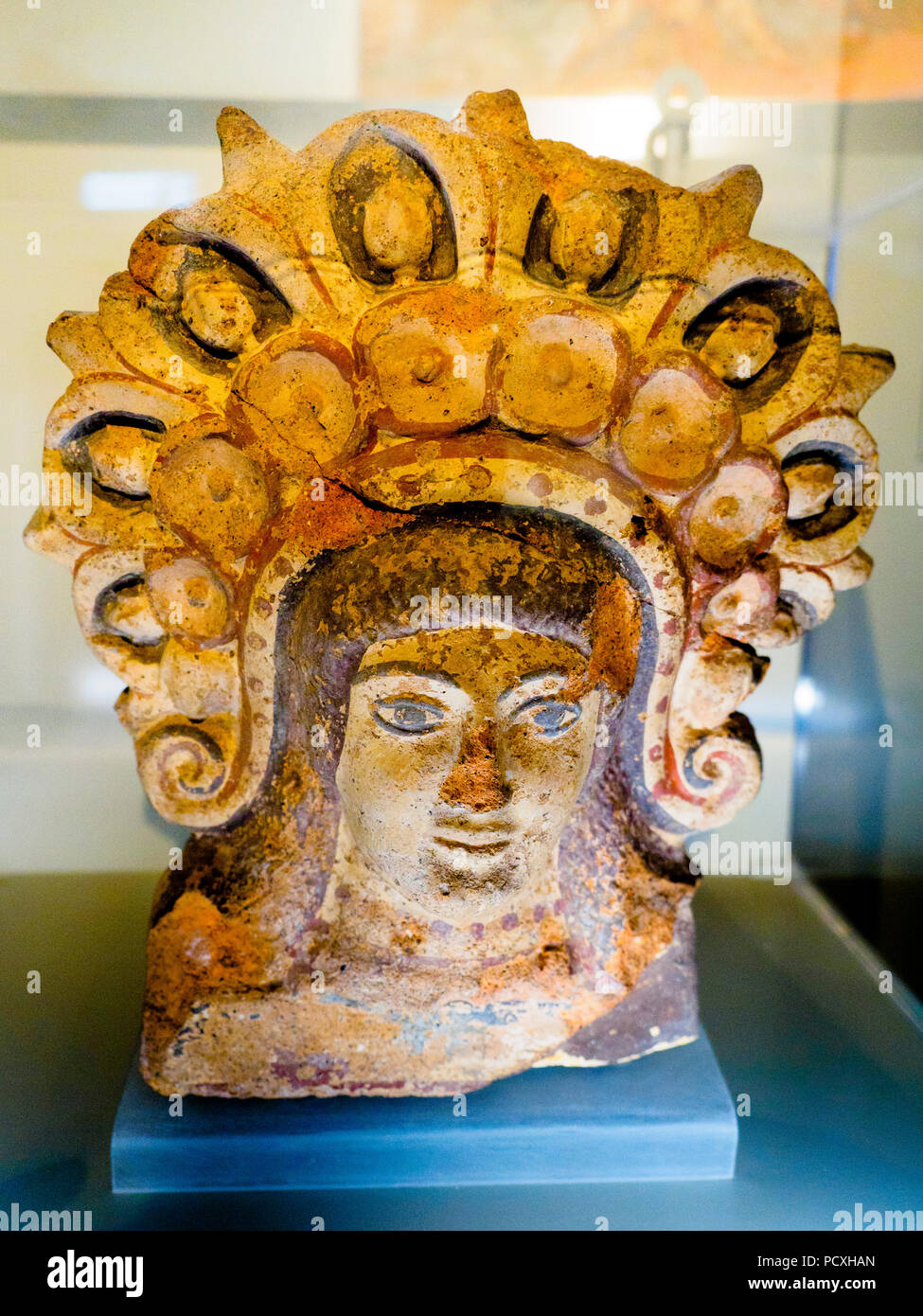 Terracotta antefix with female head framed by nimbus (shell elements ...