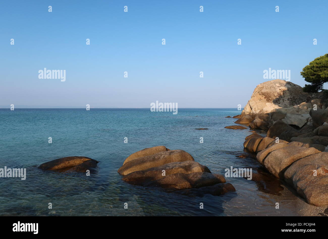 Rocks in shallow water Stock Photo - Alamy