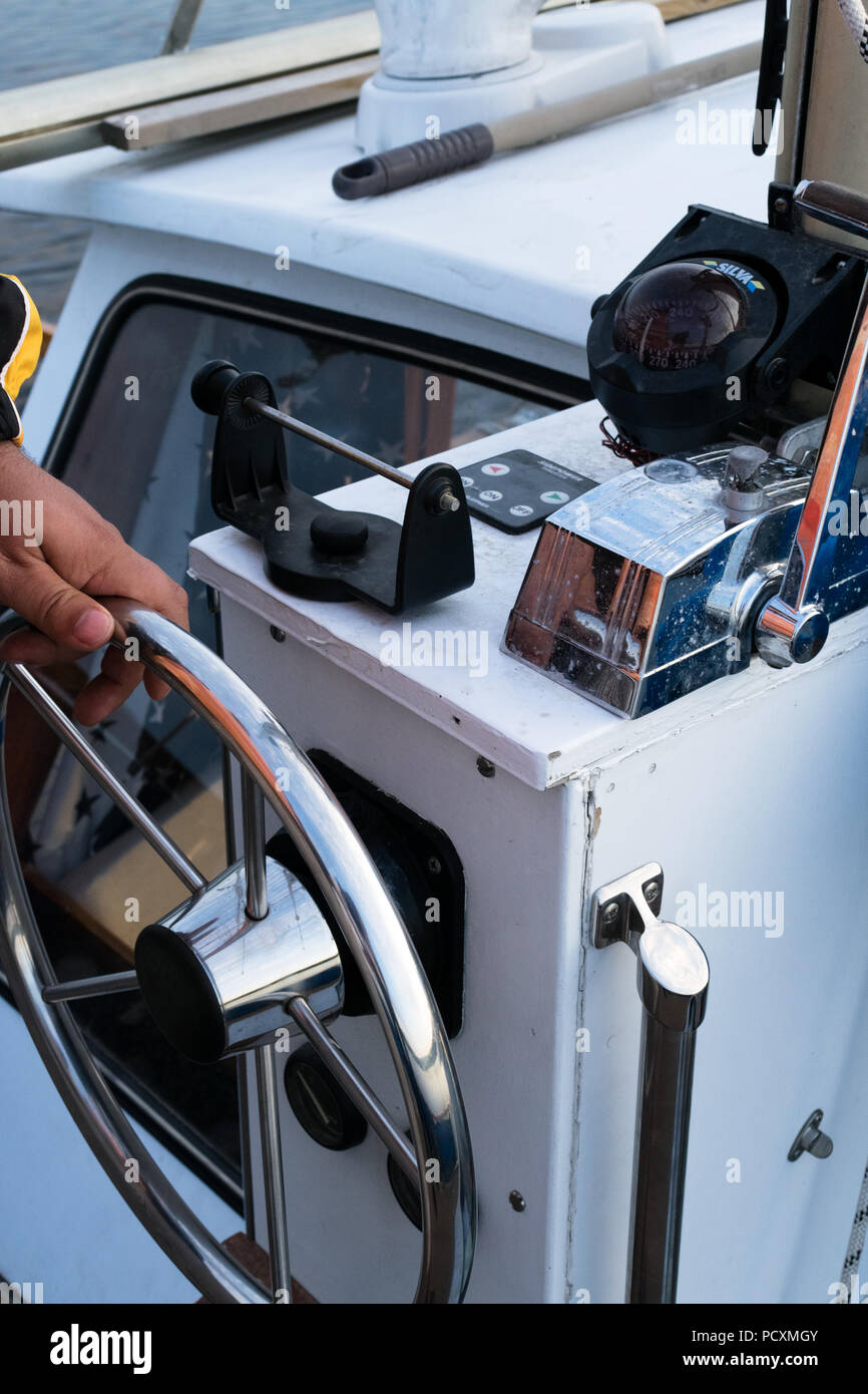 captain at the sailing yacht helm, control wheel Stock Photo - Alamy