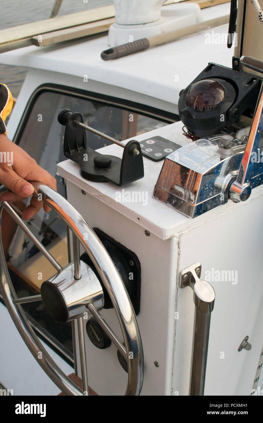 captain at the sailing yacht helm, control wheel Stock Photo - Alamy