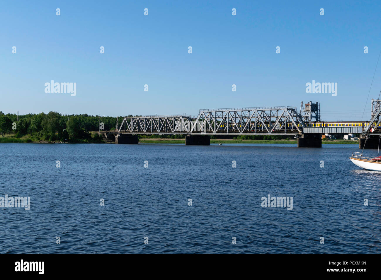 Bridge on concrete piers across the river. Metal bridge over the river ...
