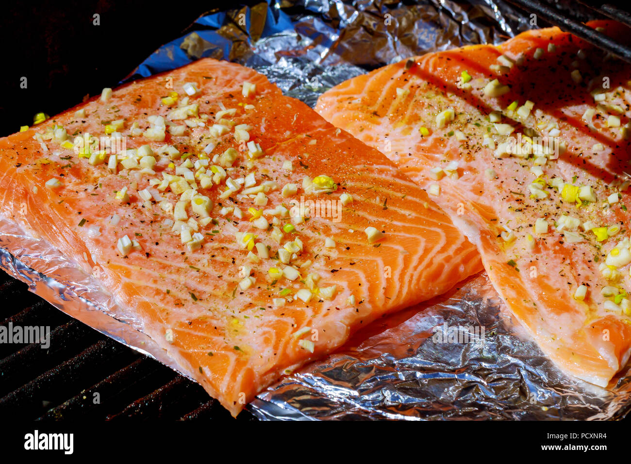 seasoned salmon fillet cooking on over grill Stock Photo - Alamy