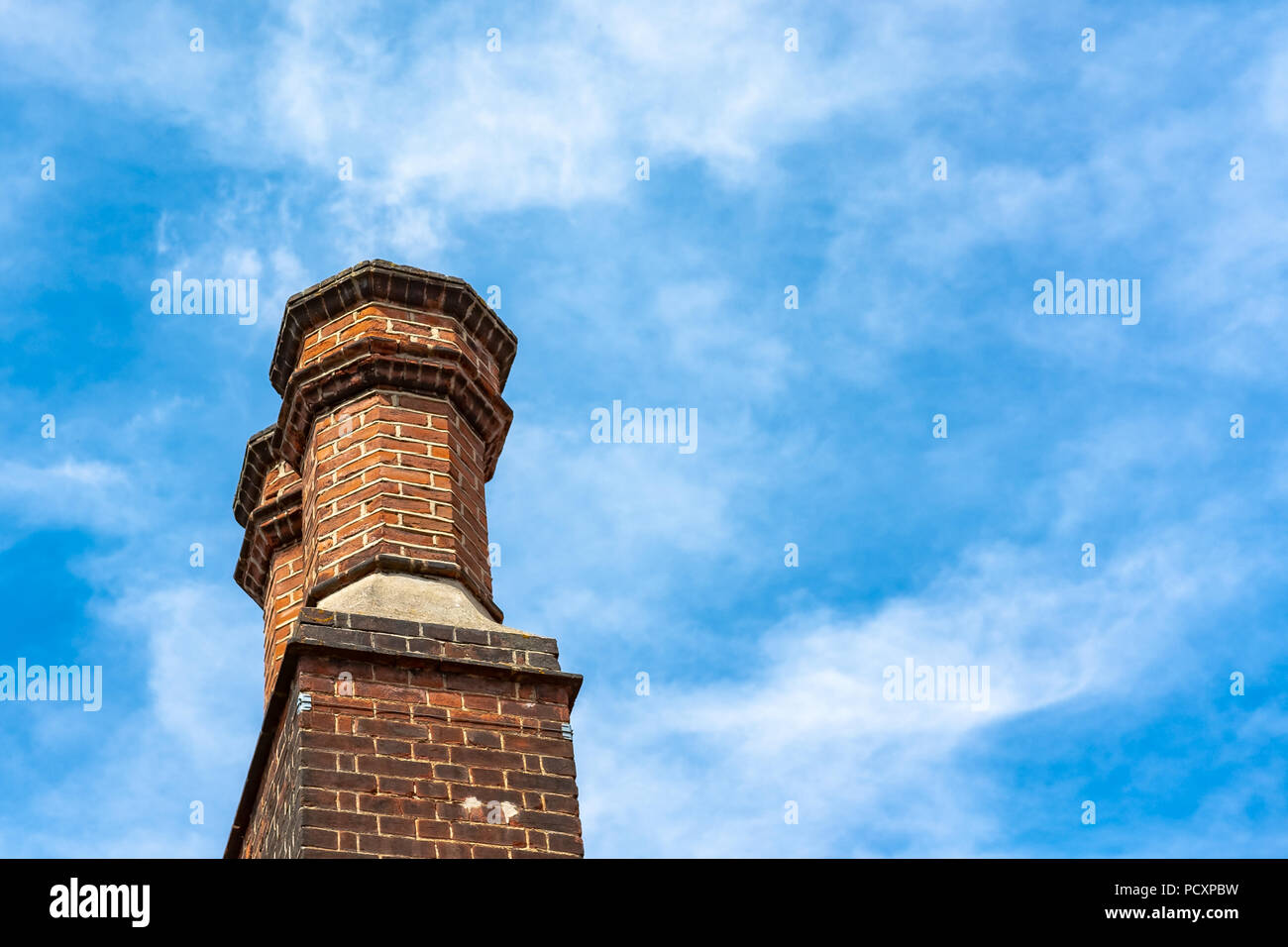 solated image of a pair of very old brick-built chimneys showing there ...