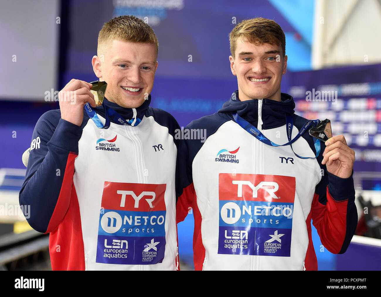 Great Britain's Adam Peaty (left) with his gold medal alongside ...