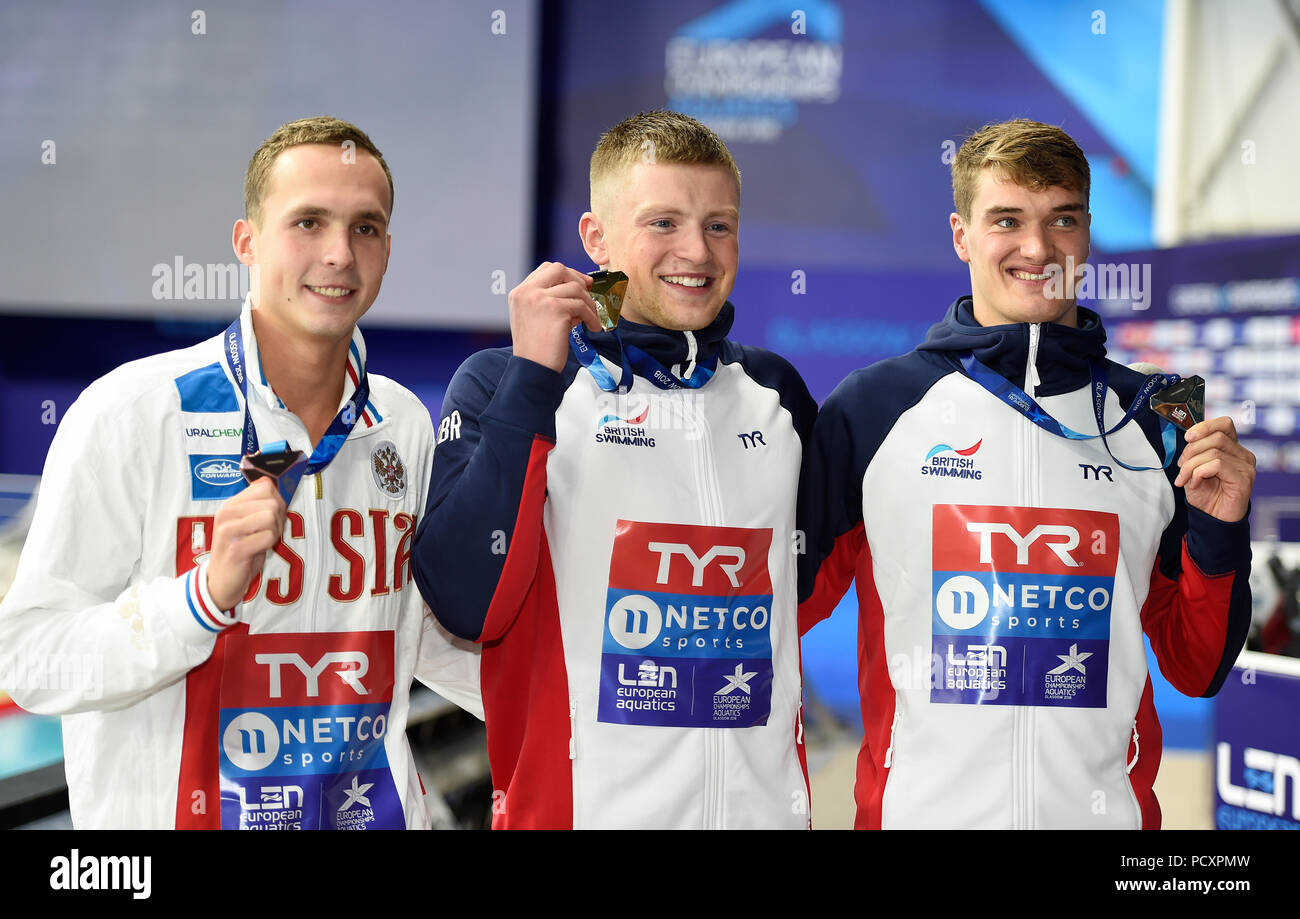 Great Britain's Adam Peaty (centre) with his gold medal alongside ...