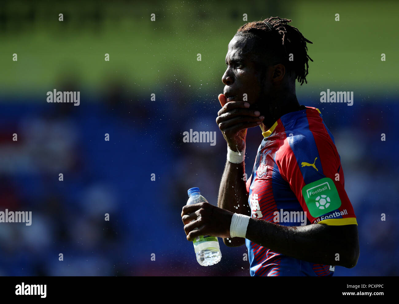 Crystal Palace's Wilfried Zaha takes a water break during the pre ...