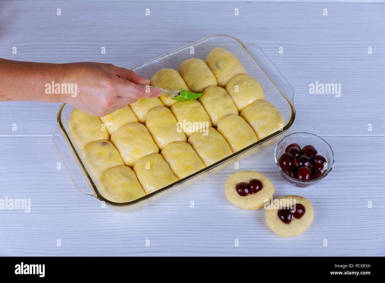 Rolls from the dough on a dripping pan before bake Homemade buns before ...