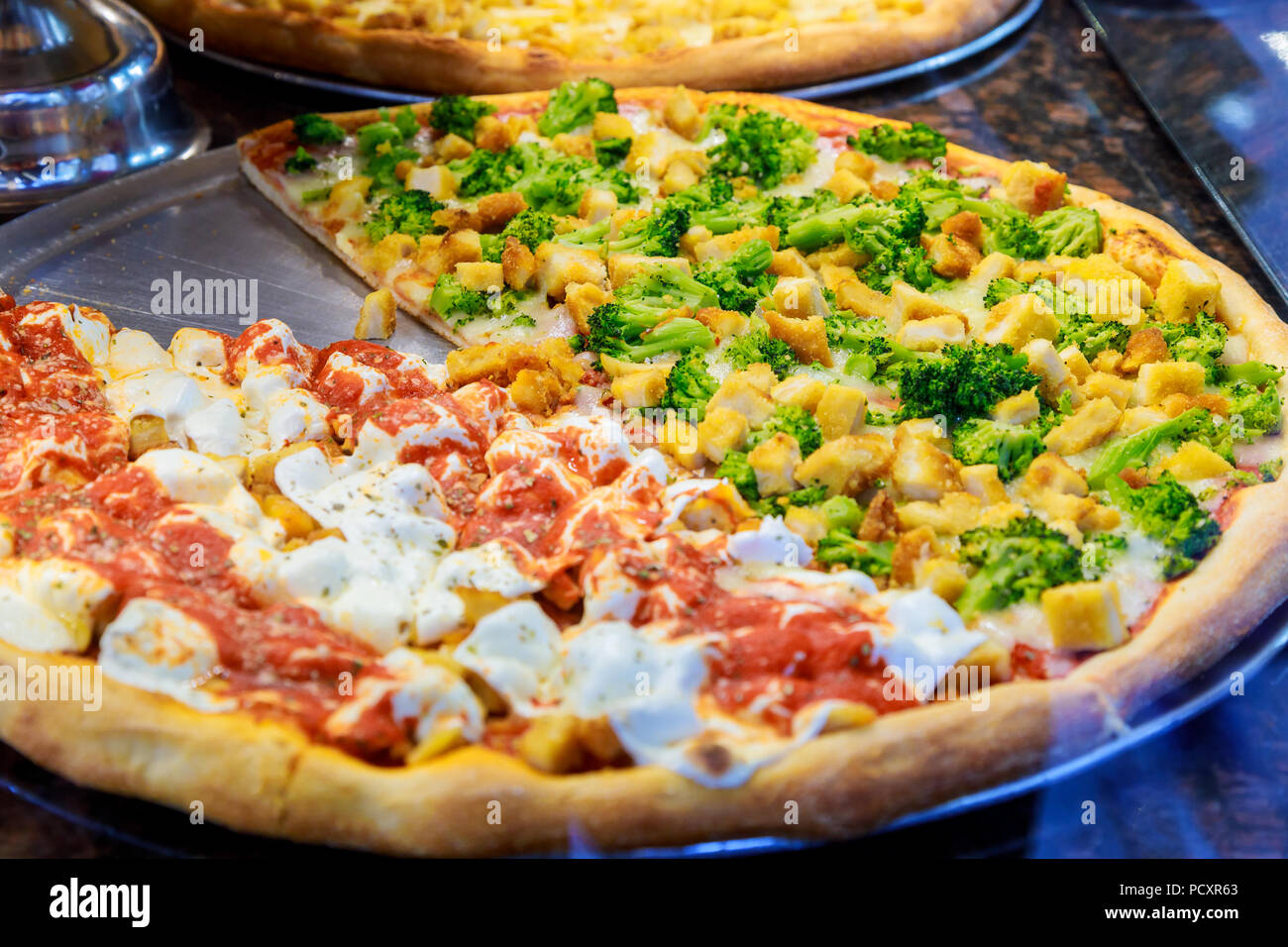 Pizza resting on a pizzeria counter the background is restaurant One ...