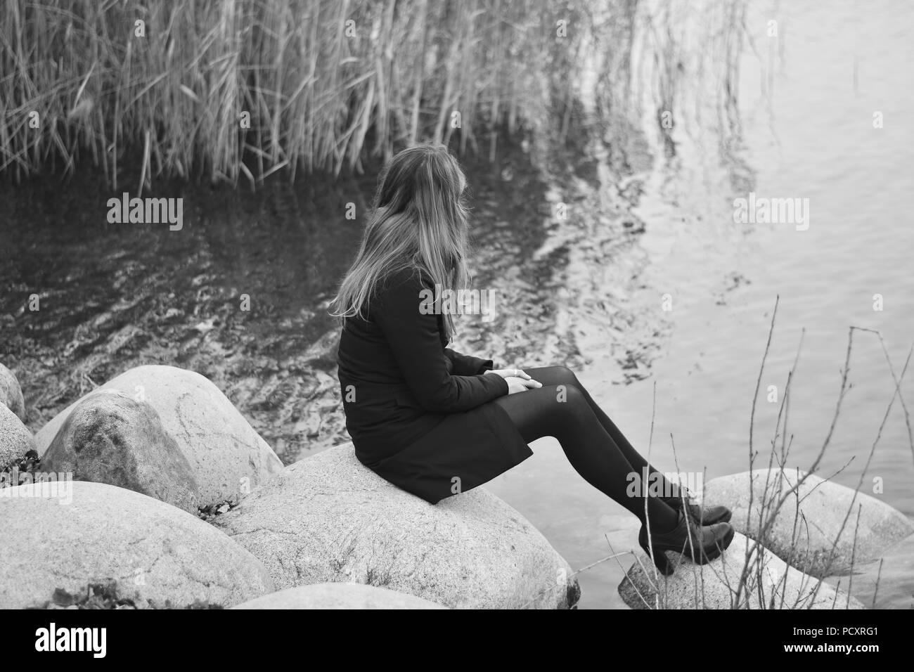 Girl sitting on new Black and White Stock Photos & Images - Alamy