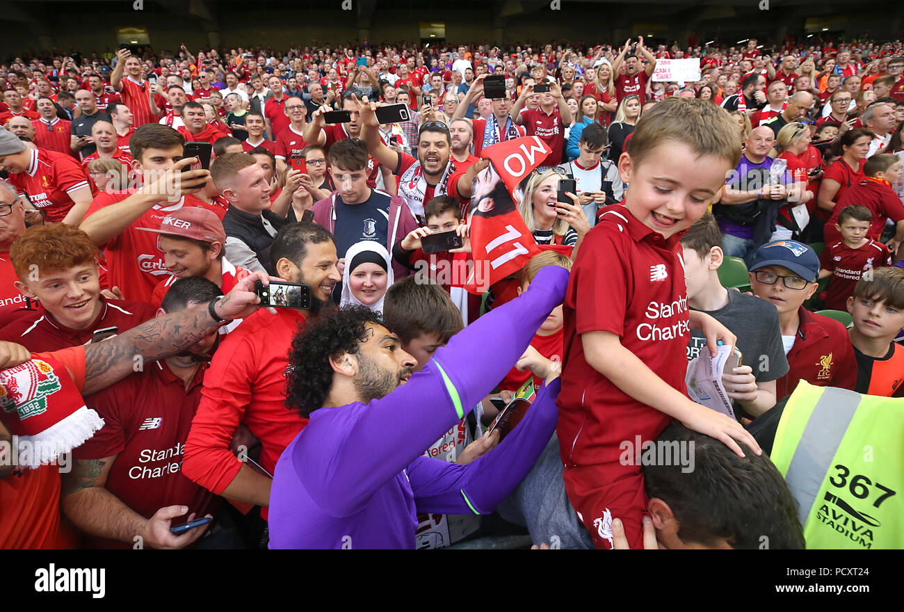 Liverpool's Mohamed Salah signs autographs for fans after the pre ...