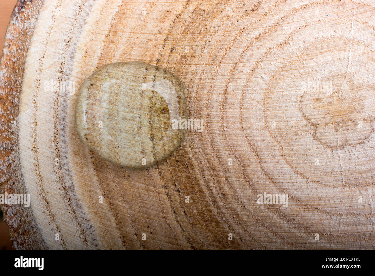 Round water drops in close-up view on wooden background Stock Photo - Alamy