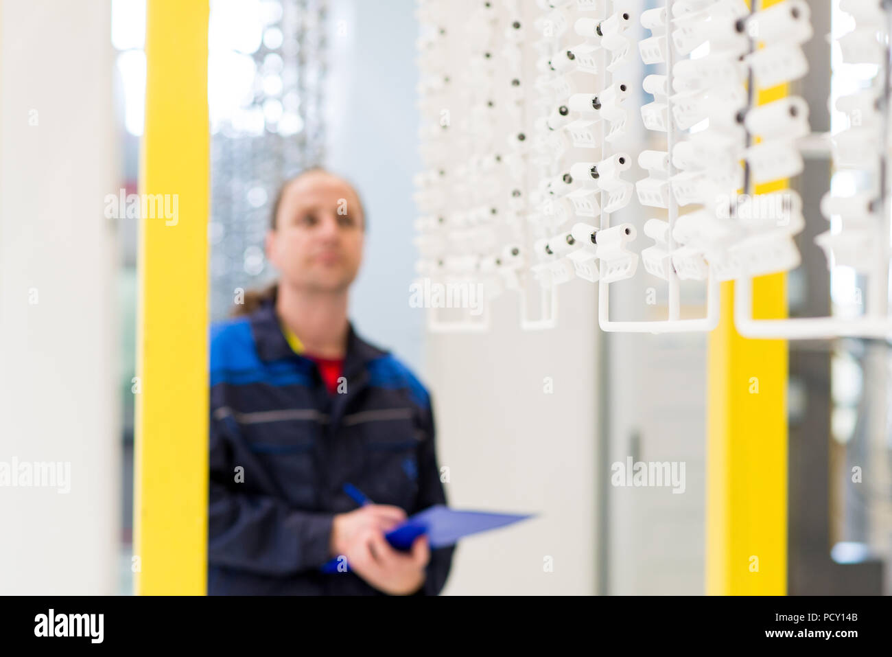 Factory worker checking products on production line. Worker taking ...