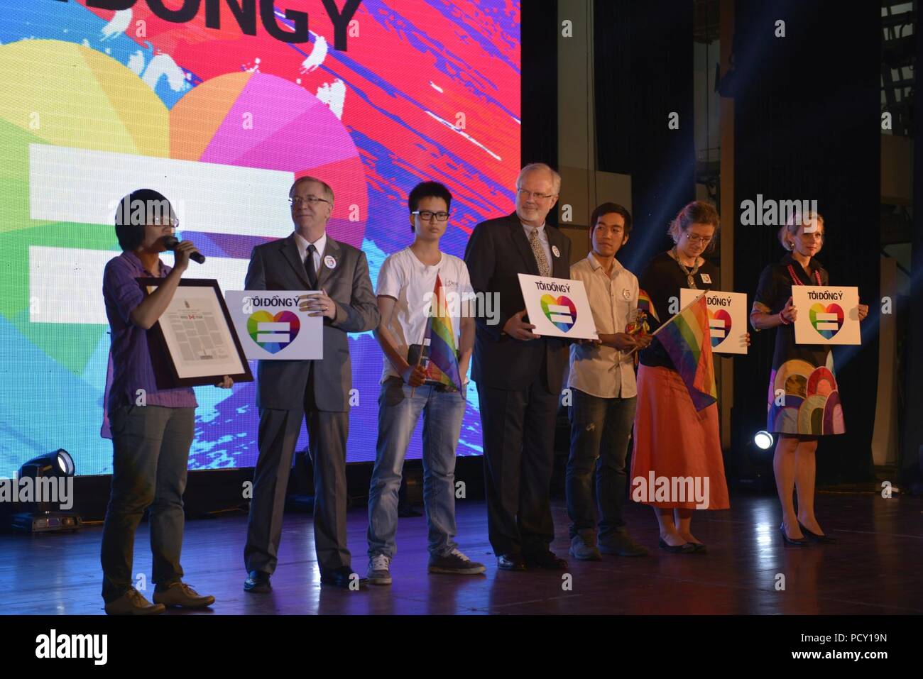 Ambassador David Shear helps to present a gift to the LGBT community ...