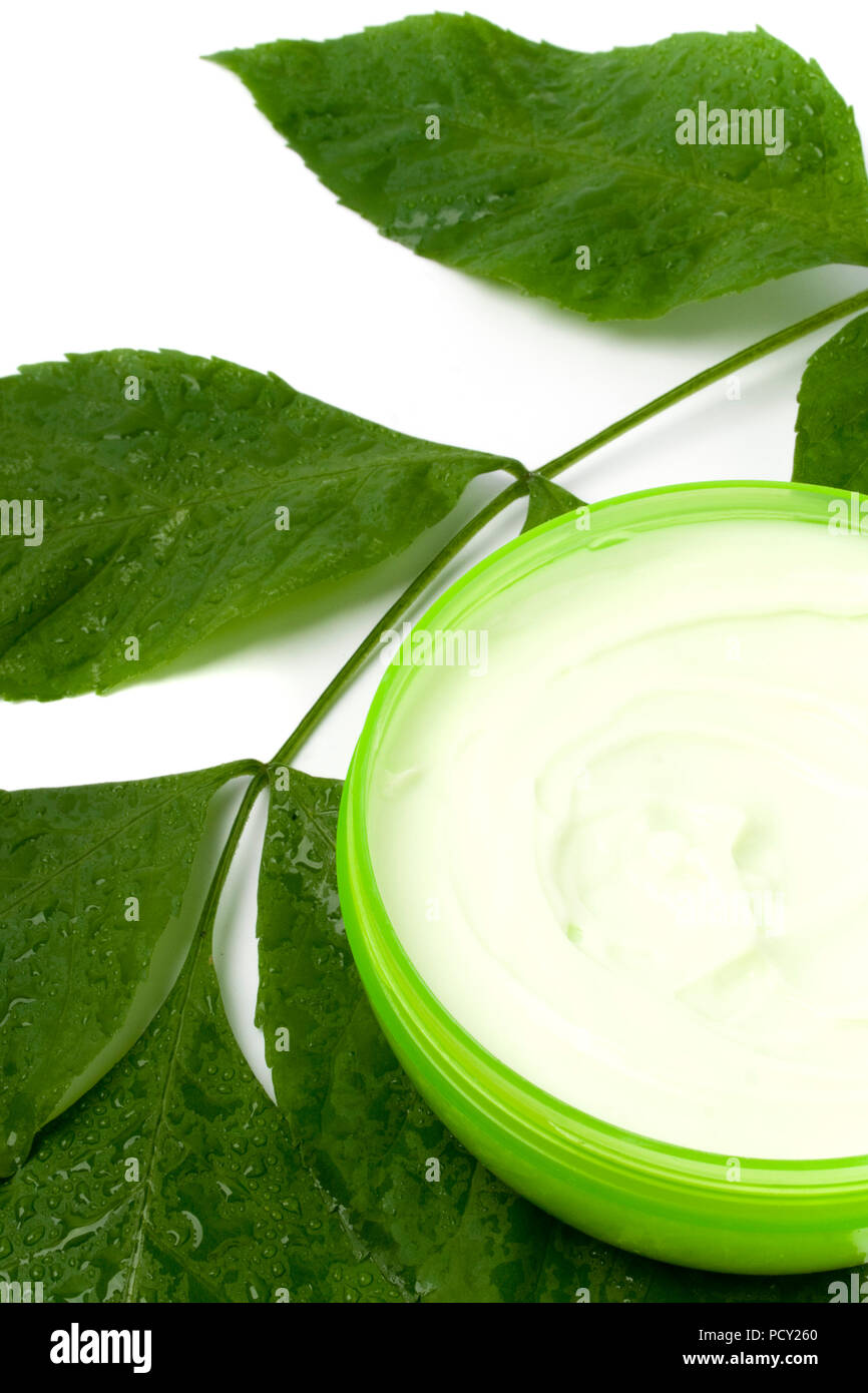 face cream with green leaf on white background Stock Photo - Alamy