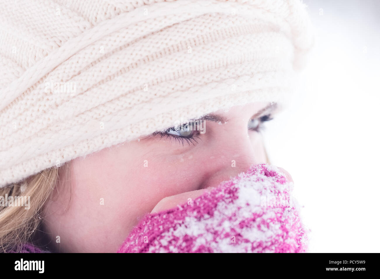 Portrait of young woman covering her face with hand to protect from ...