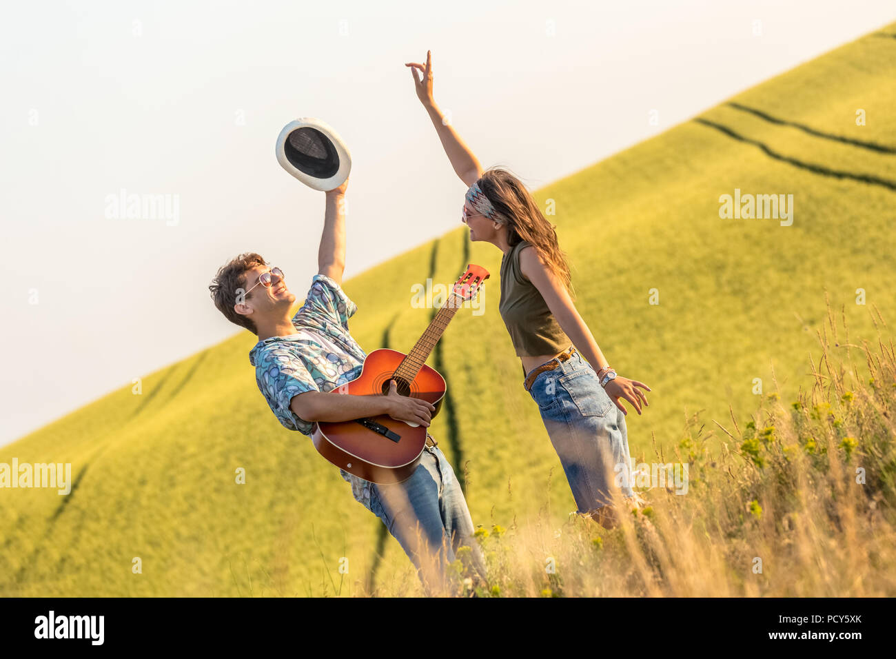 Romantic hipster couple singing their favorite song in nature. Love and ...