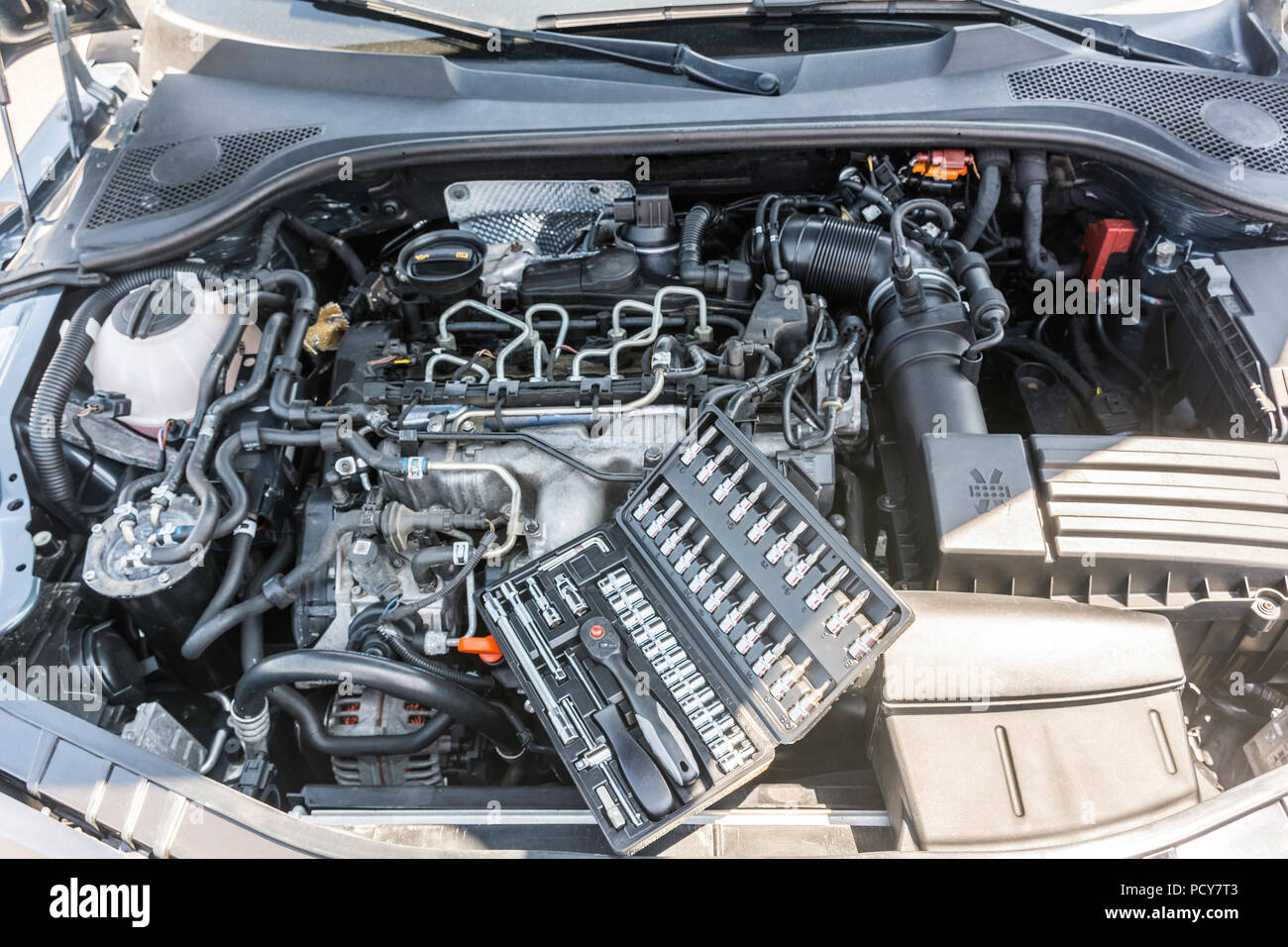 Top vertical view of car engine bay and open tool box with specialized ...