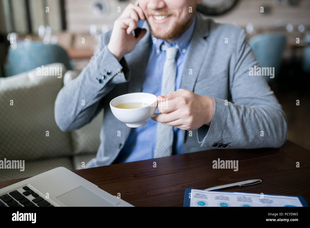 Man drinking tea during work Stock Photo - Alamy