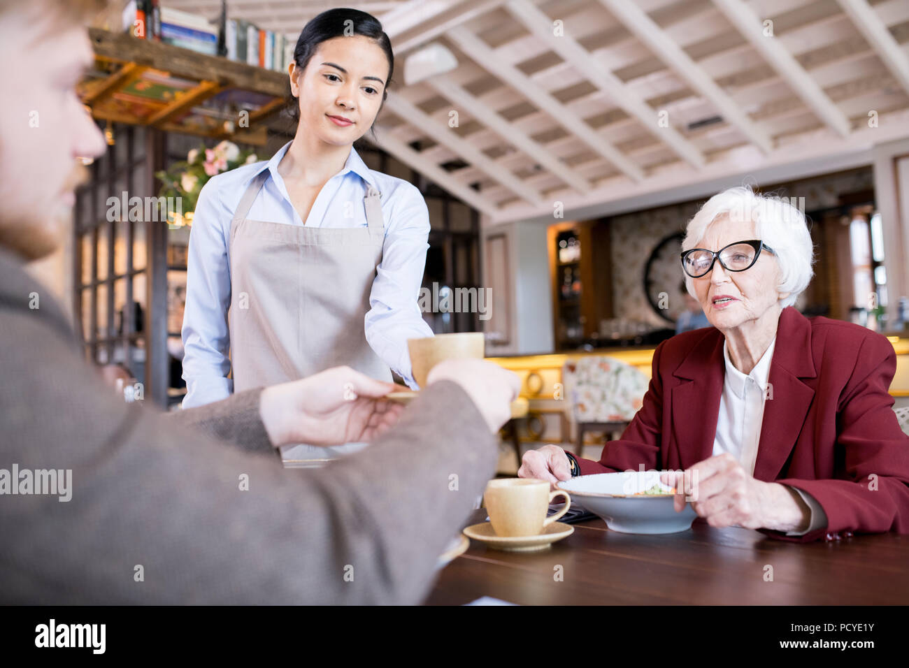 Drinking coffee at cafe Stock Photo - Alamy