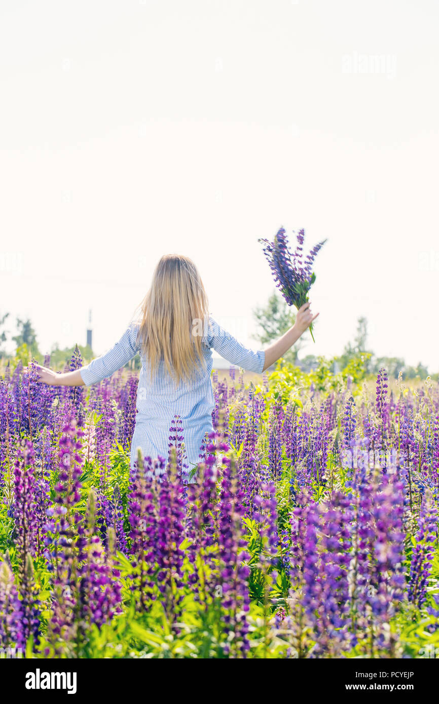 The girl is running across the field Stock Photo - Alamy
