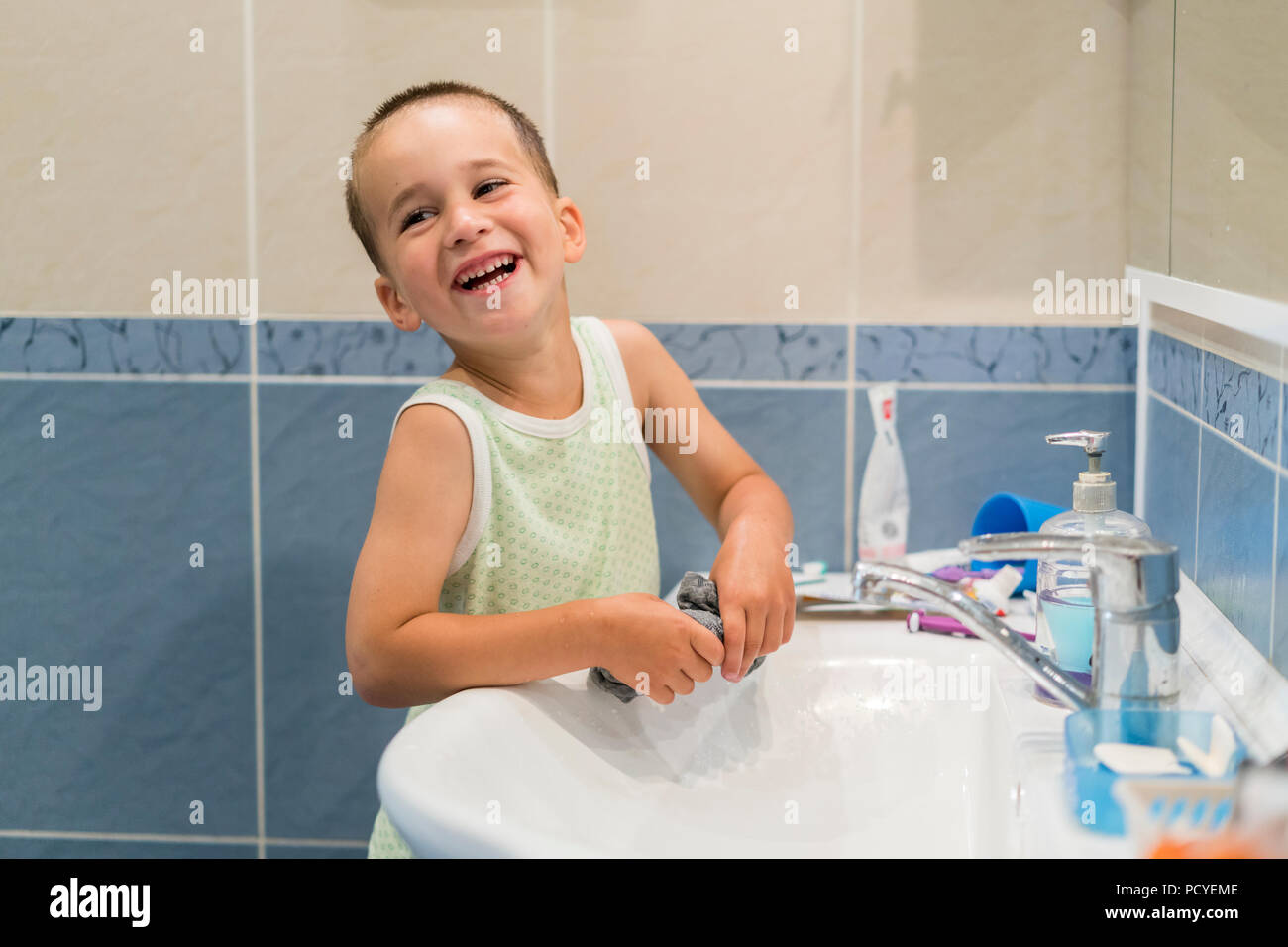 A little boy is washing clothes in the bathroom Stock Photo - Alamy