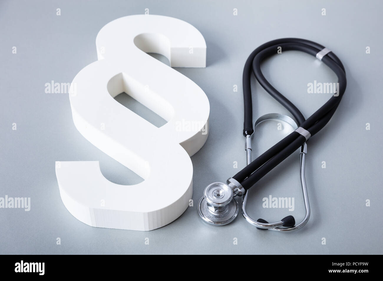 Close-up Of Stethoscope And Paragraph Symbol On Grey Background Stock ...