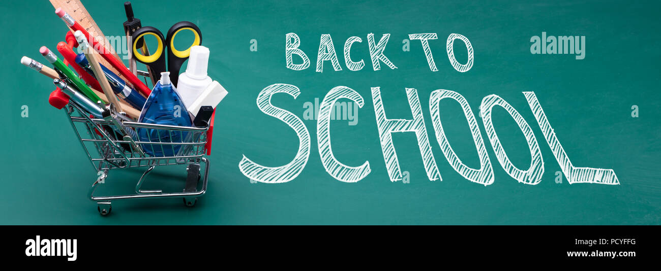 Shopping Cart Filled With School Supplies On Blackboard With Back To ...