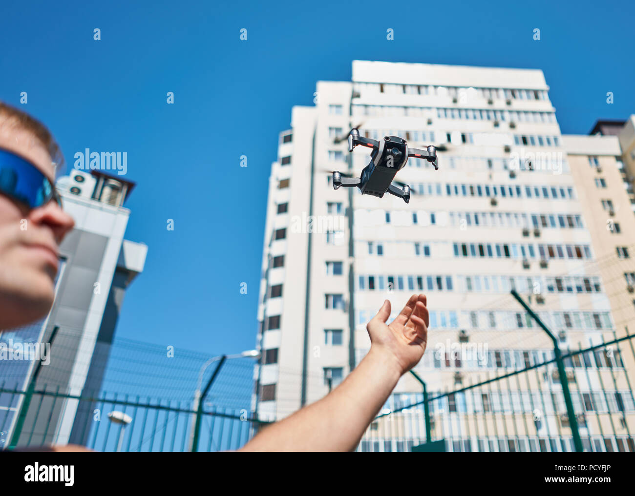 man launches quadcopter Stock Photo - Alamy