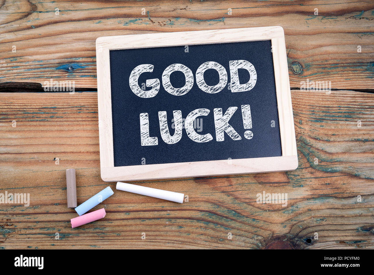 Good luck. blackboard and old wooden table Stock Photo - Alamy