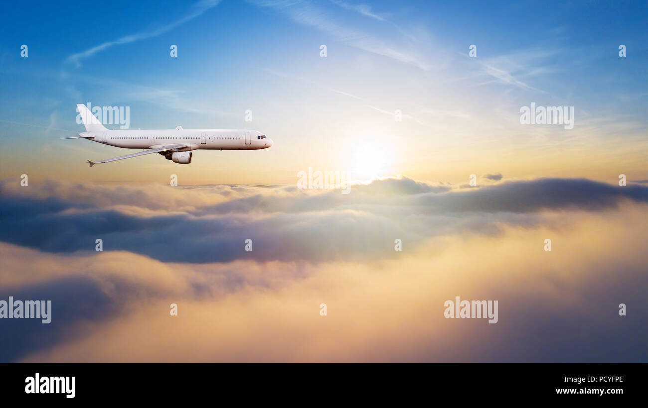 Detail of side view of commercial airplane flying above clouds ...