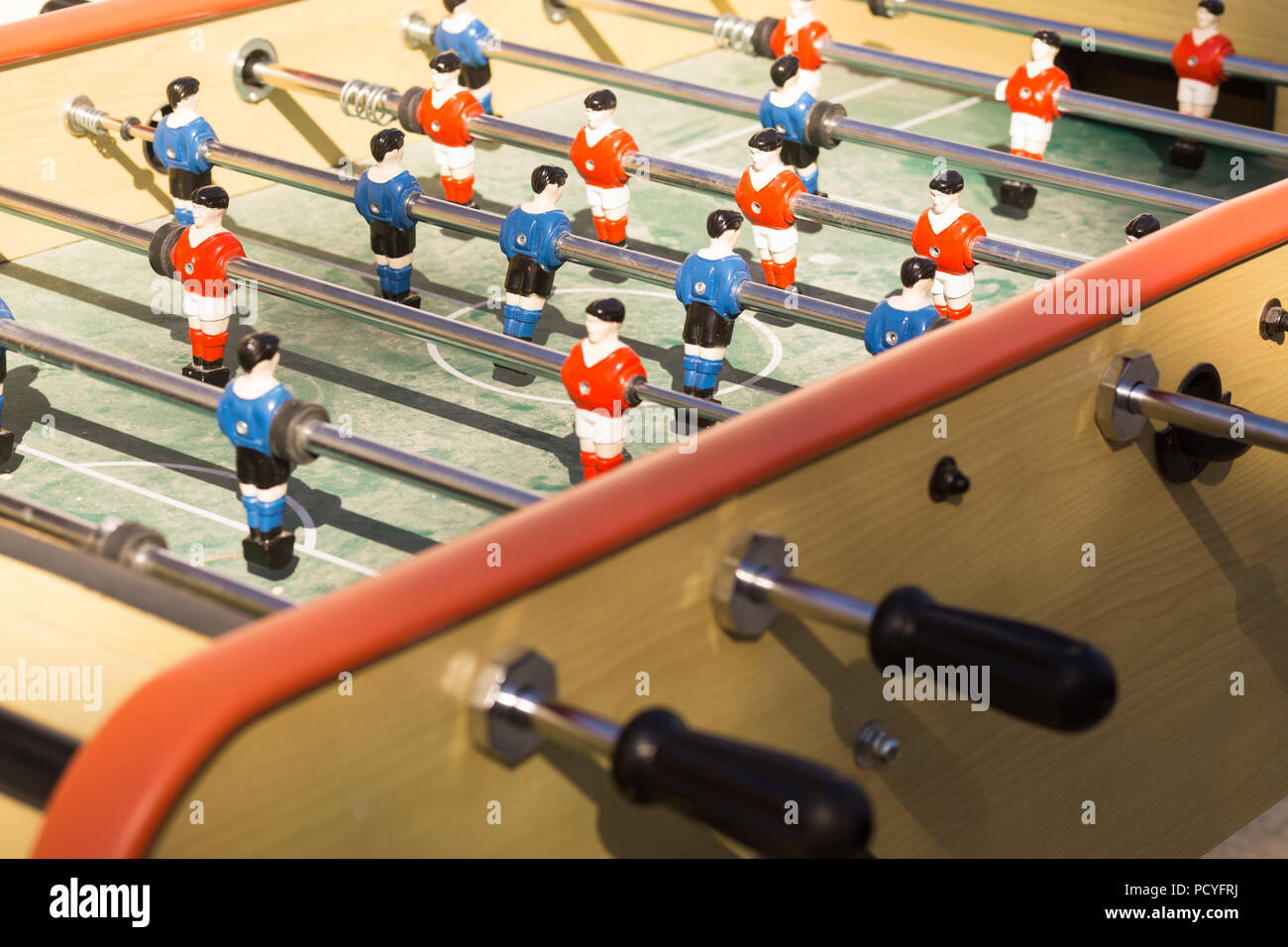 Close up of table football (foosball) with players in red and blue ...