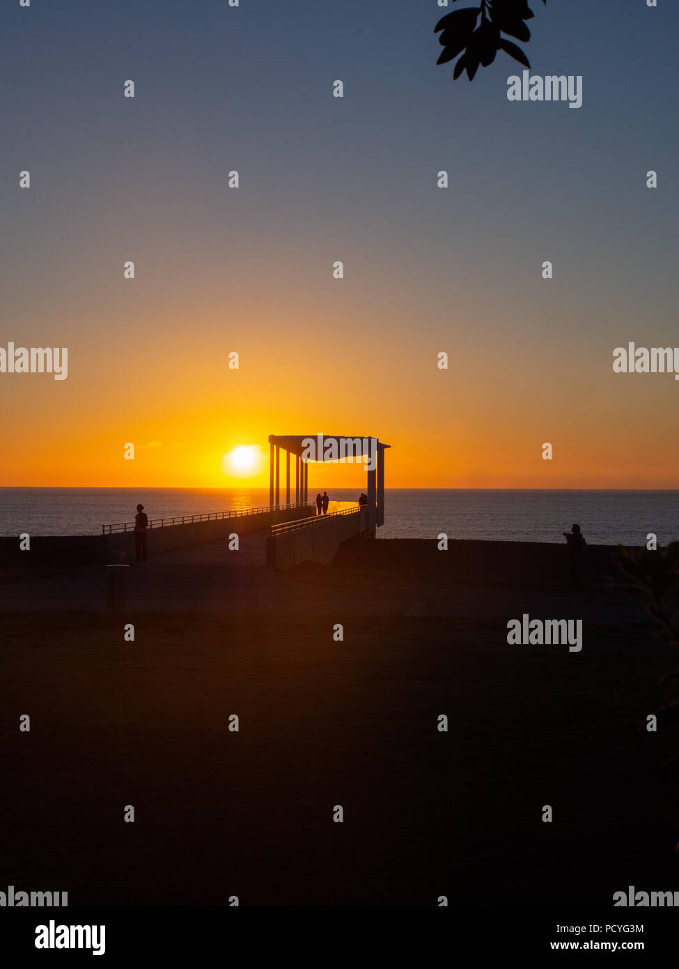 Sun Rising Over The Horizon From The Beach Stock Photo - Alamy
