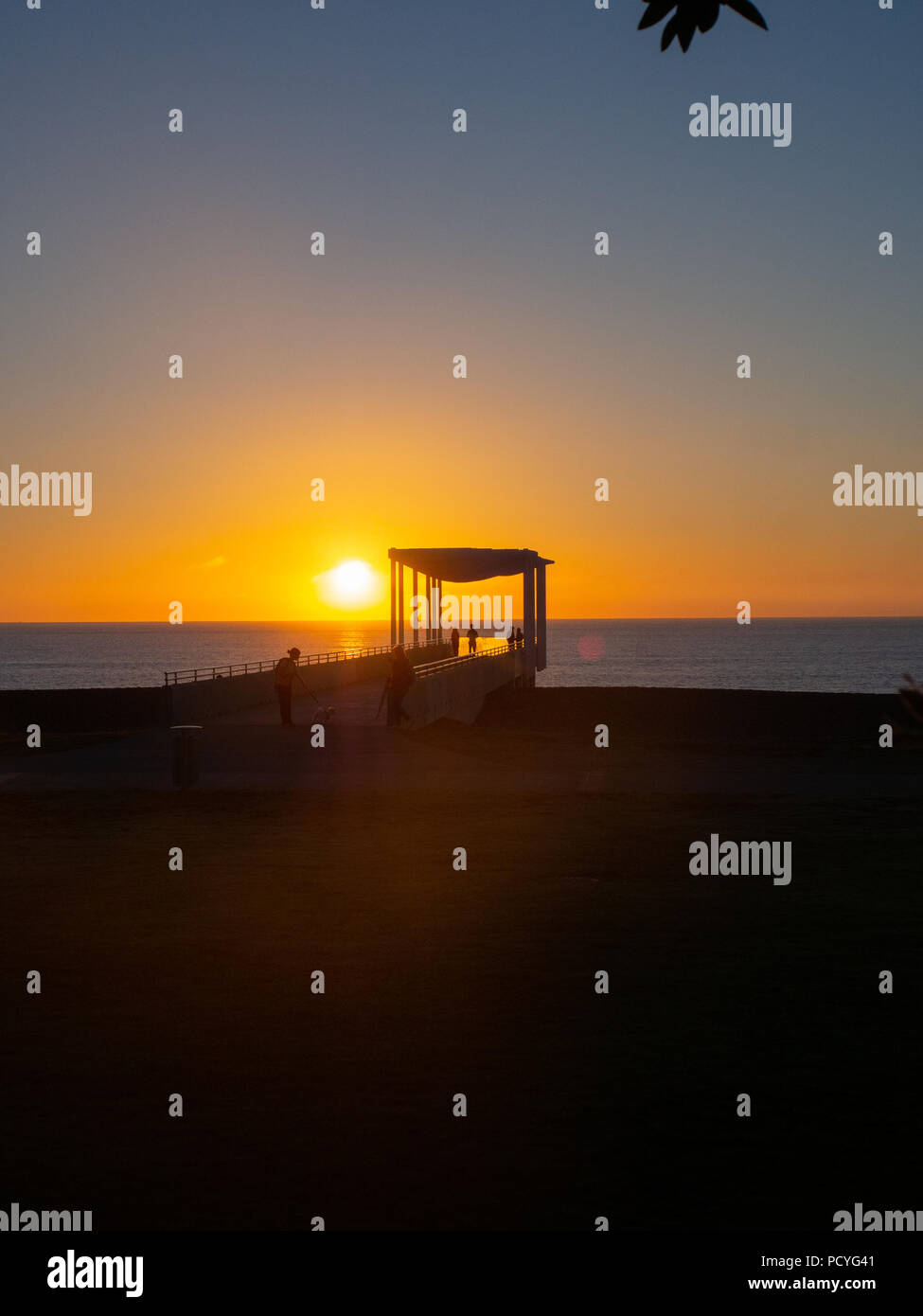 Sun Rising Over The Horizon From The Beach Stock Photo - Alamy