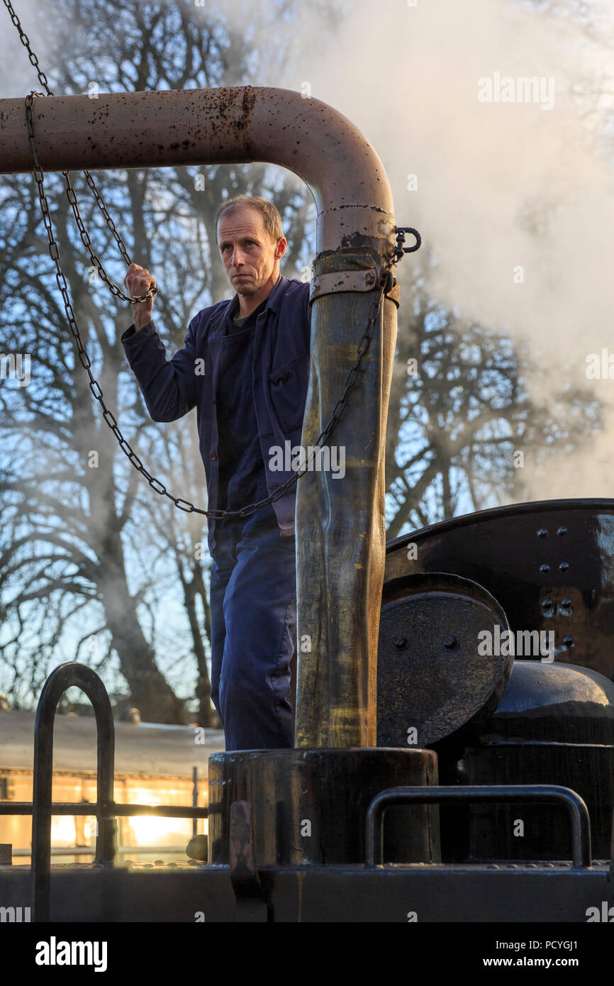 A fireman fills a steam locomotive with water, at the Dartmouth Stream ...
