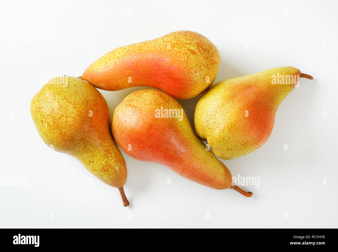 four ripe pears on white background Stock Photo - Alamy
