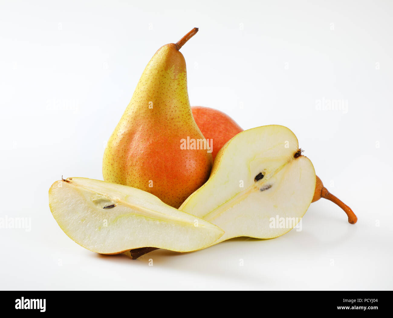 whole and halved pears on white background Stock Photo - Alamy