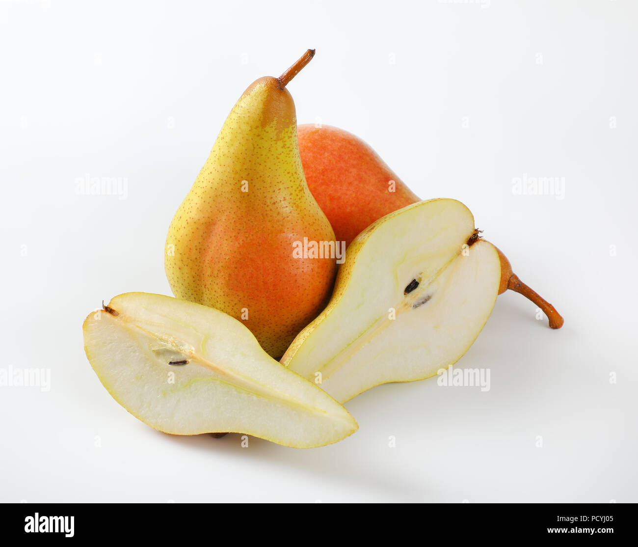 whole and halved pears on white background Stock Photo - Alamy