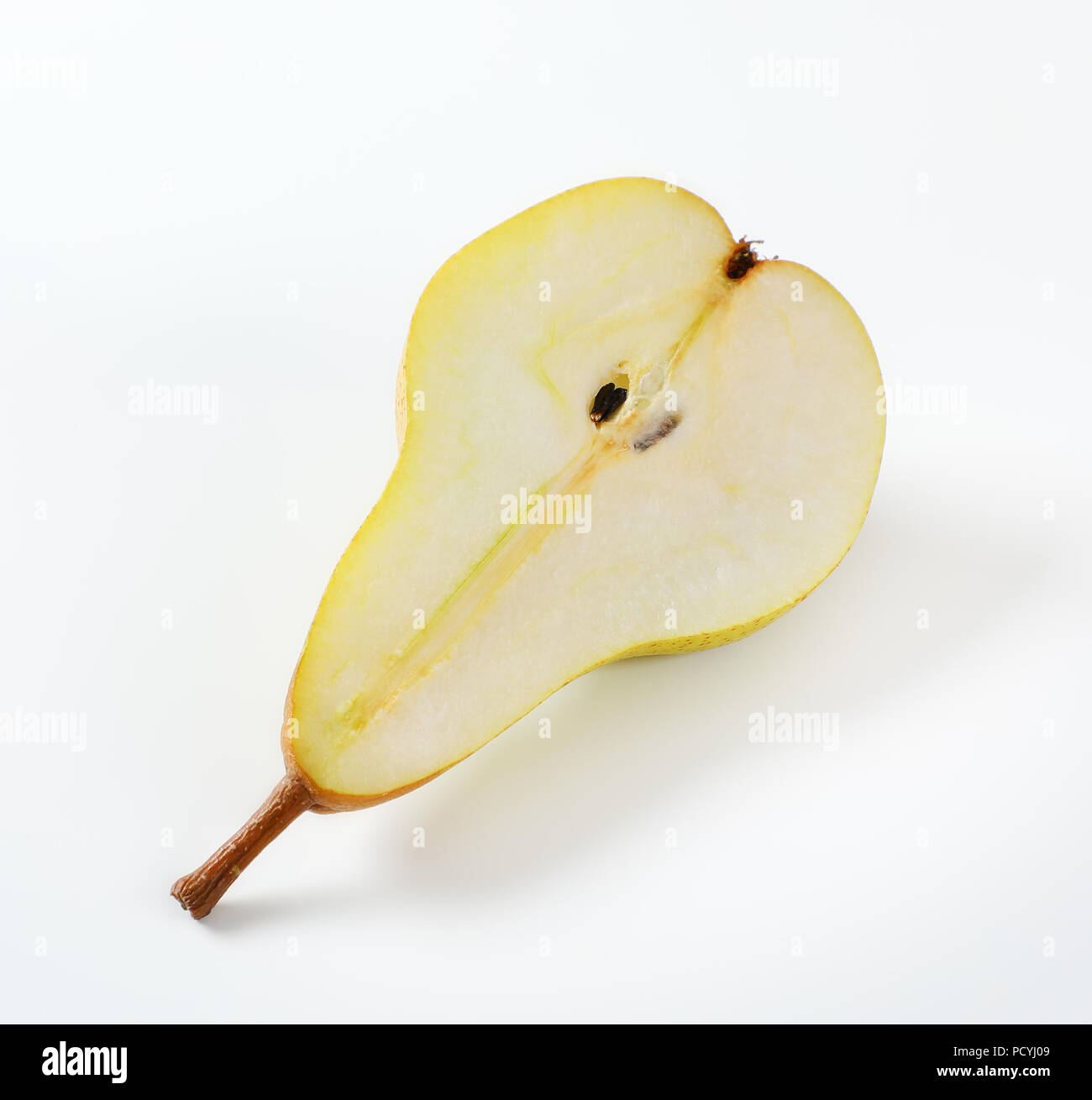 half a yellow pear on white background Stock Photo - Alamy
